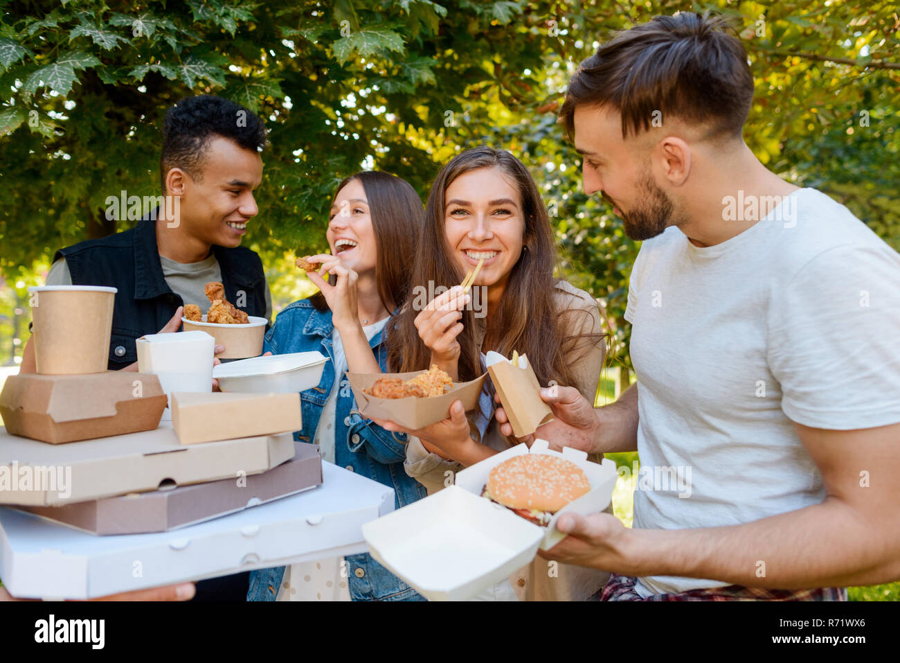 Friends are eating fast food Stock Photo - Alamy