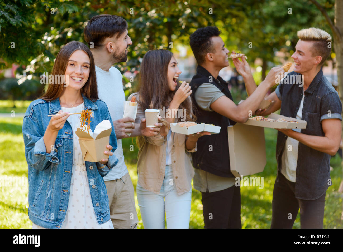 Friends eating fast food Stock Photo - Alamy