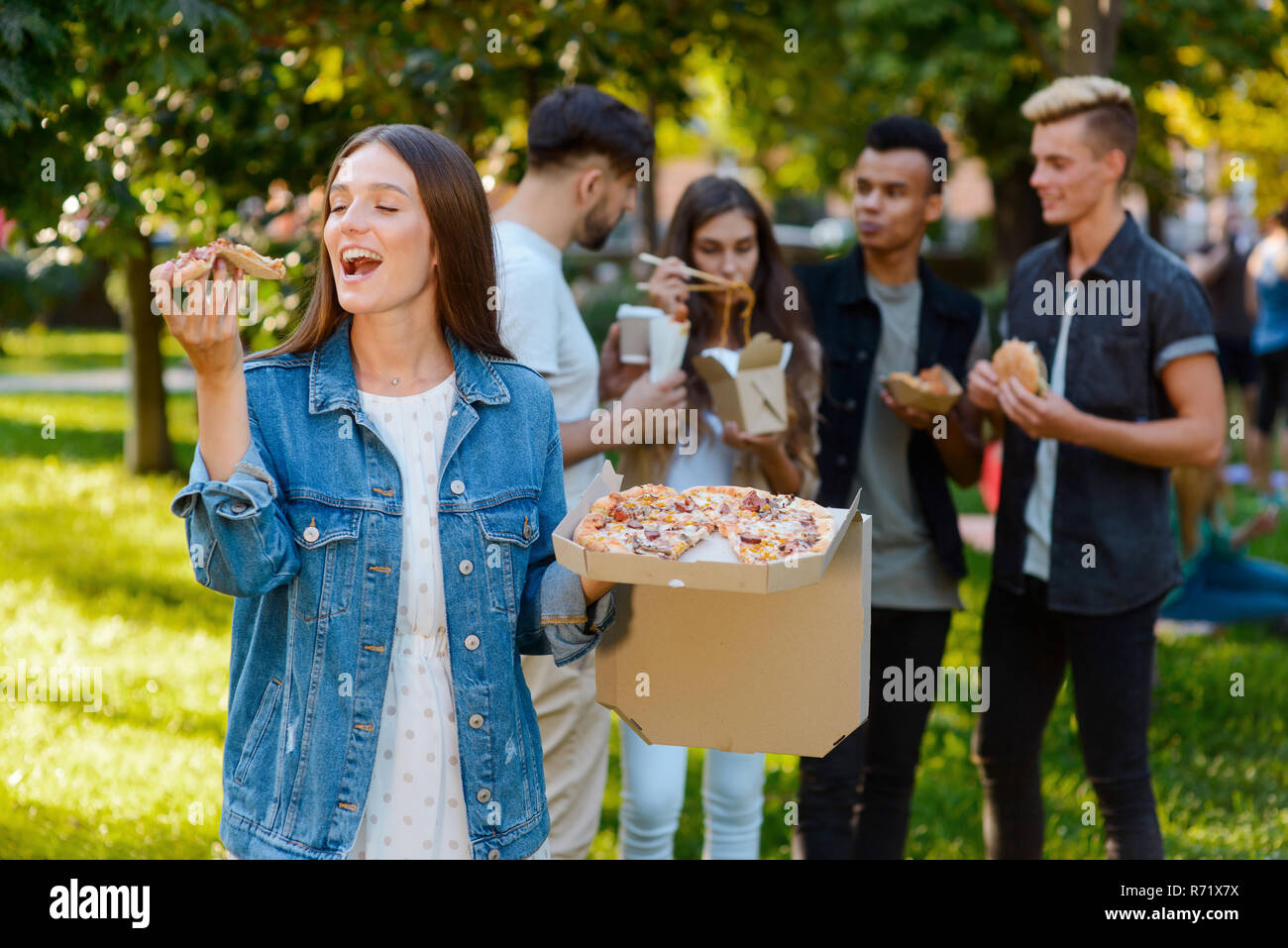 Girl taking a bite Stock Photo - Alamy Girl taking a bite Stock Photo - Alamy