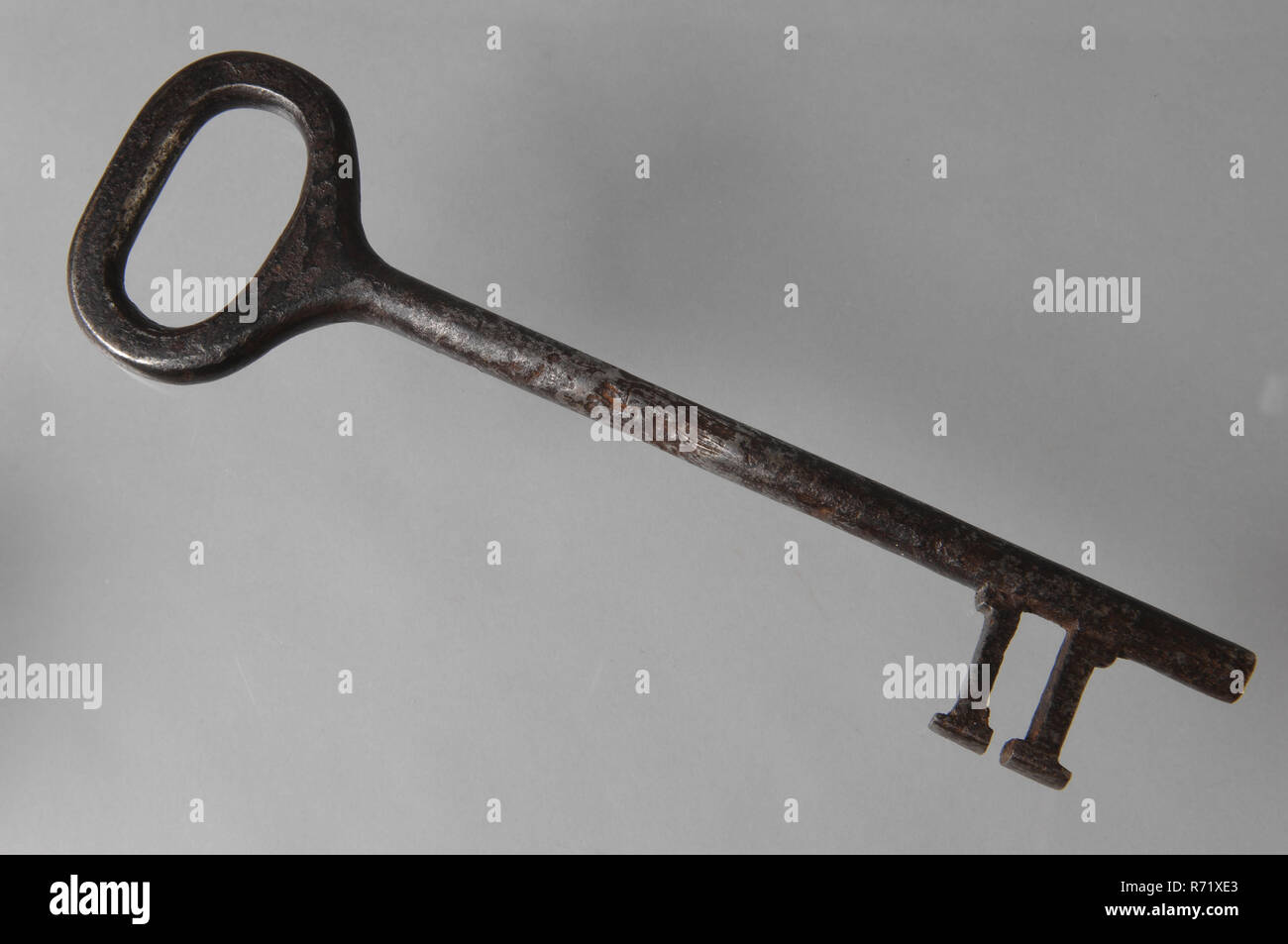 Large iron key with oval eye, elongated massive key handle and simple ...
