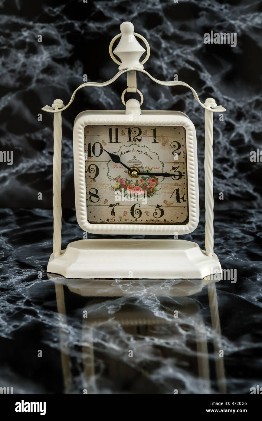 Decorative White Vintage Clock on Wrought Iron Stock Photo - Alamy