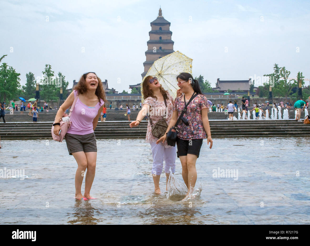 Local people playing with the water during summer in the Music Fountain ...