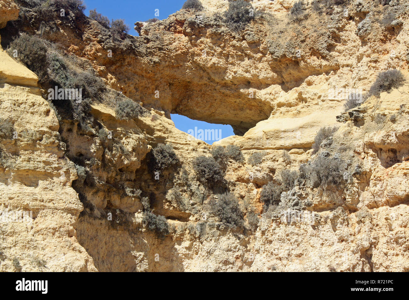 yellow rocks with hole Stock Photo - Alamy