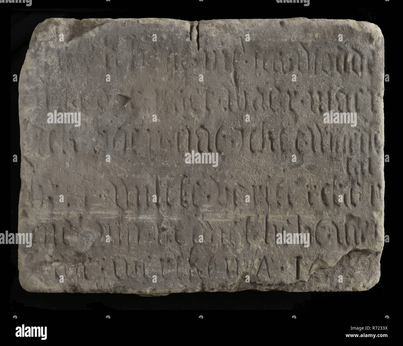 Facade stone with text in Gothic letters, facing brick building ...