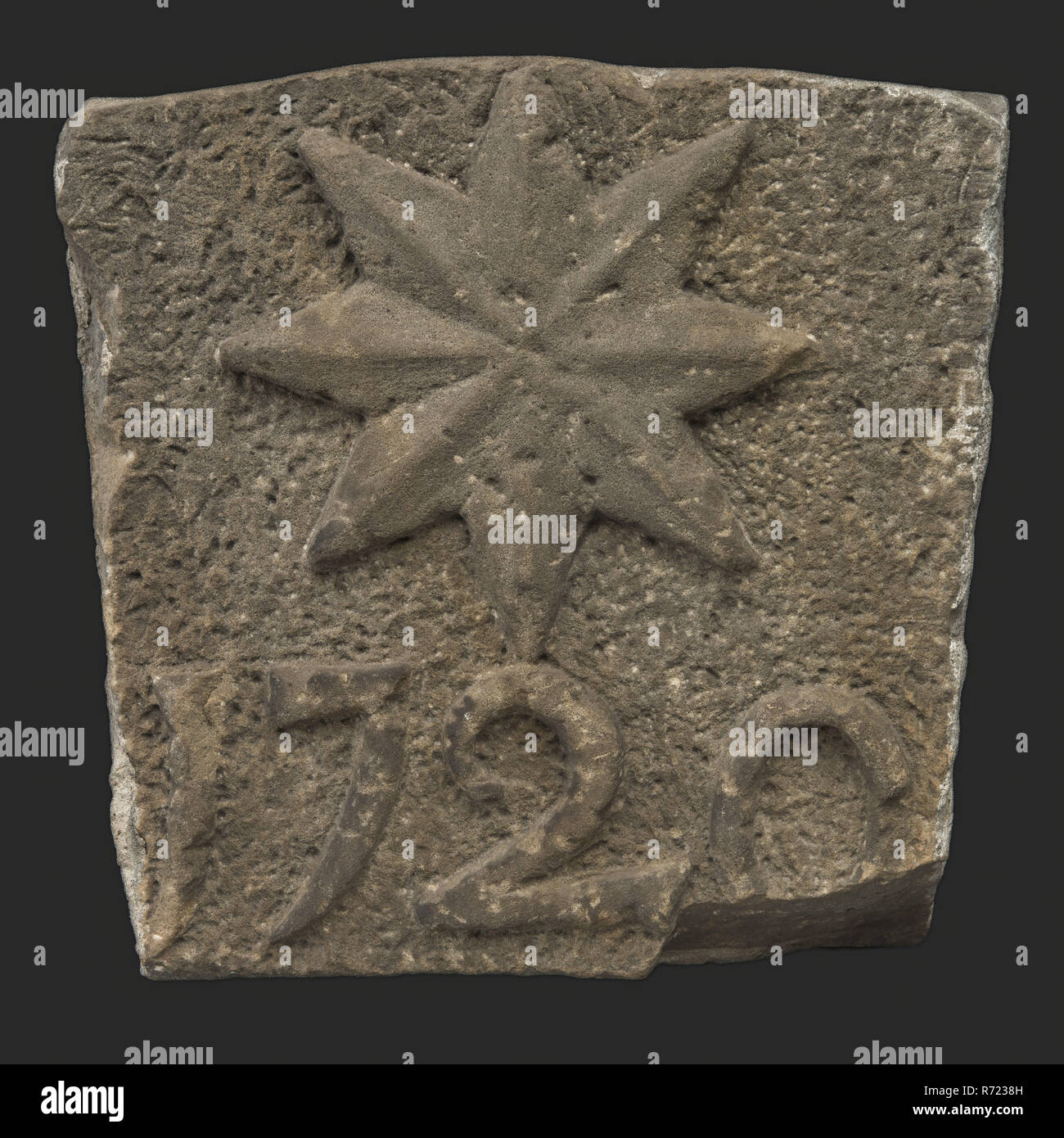 Facade stone with eight-pointed star and 1720, facing brick sculpture ...