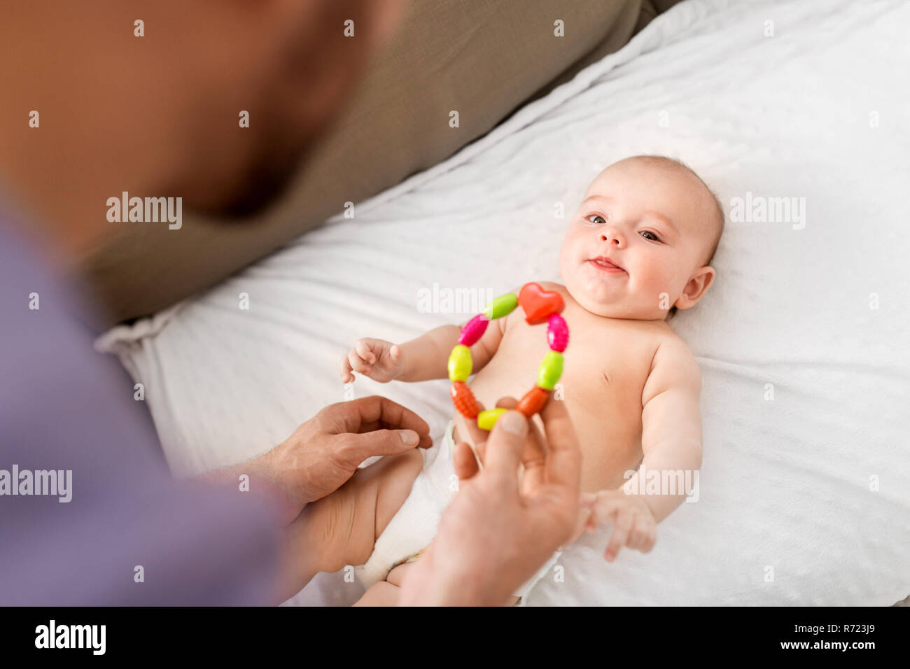Man giving toy for baby hi-res stock photography and images - Alamy