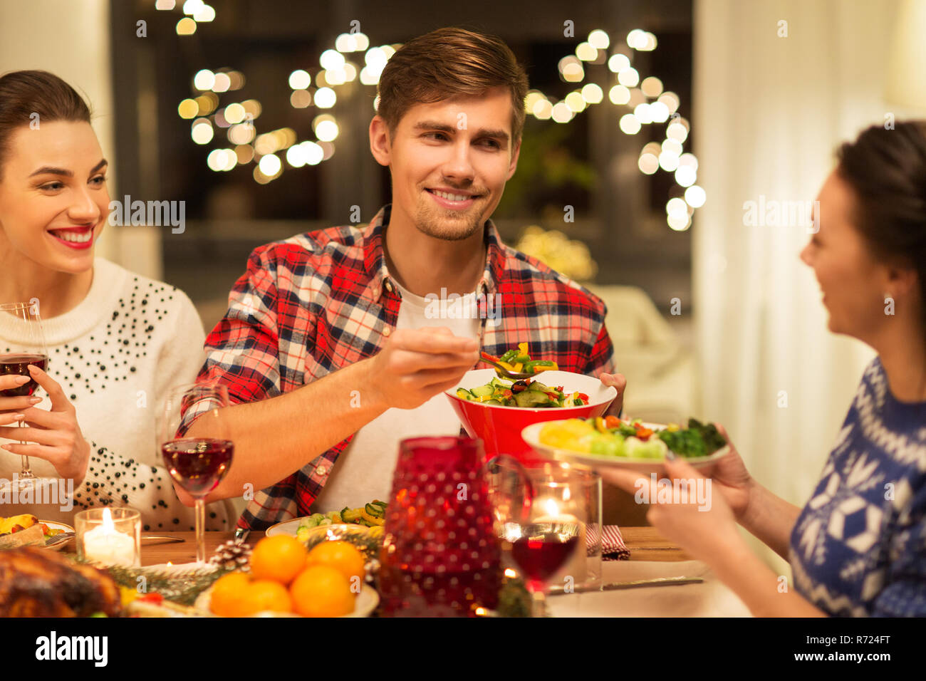 happy friends having christmas dinner at home Stock Photo - Alamy