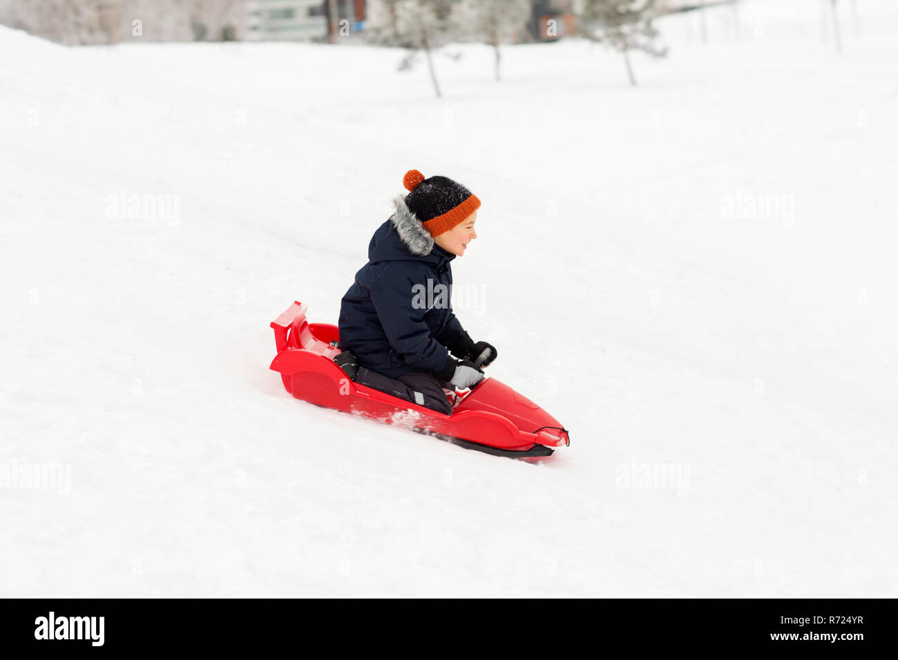 Boy sled riding hi-res stock photography and images - Alamy