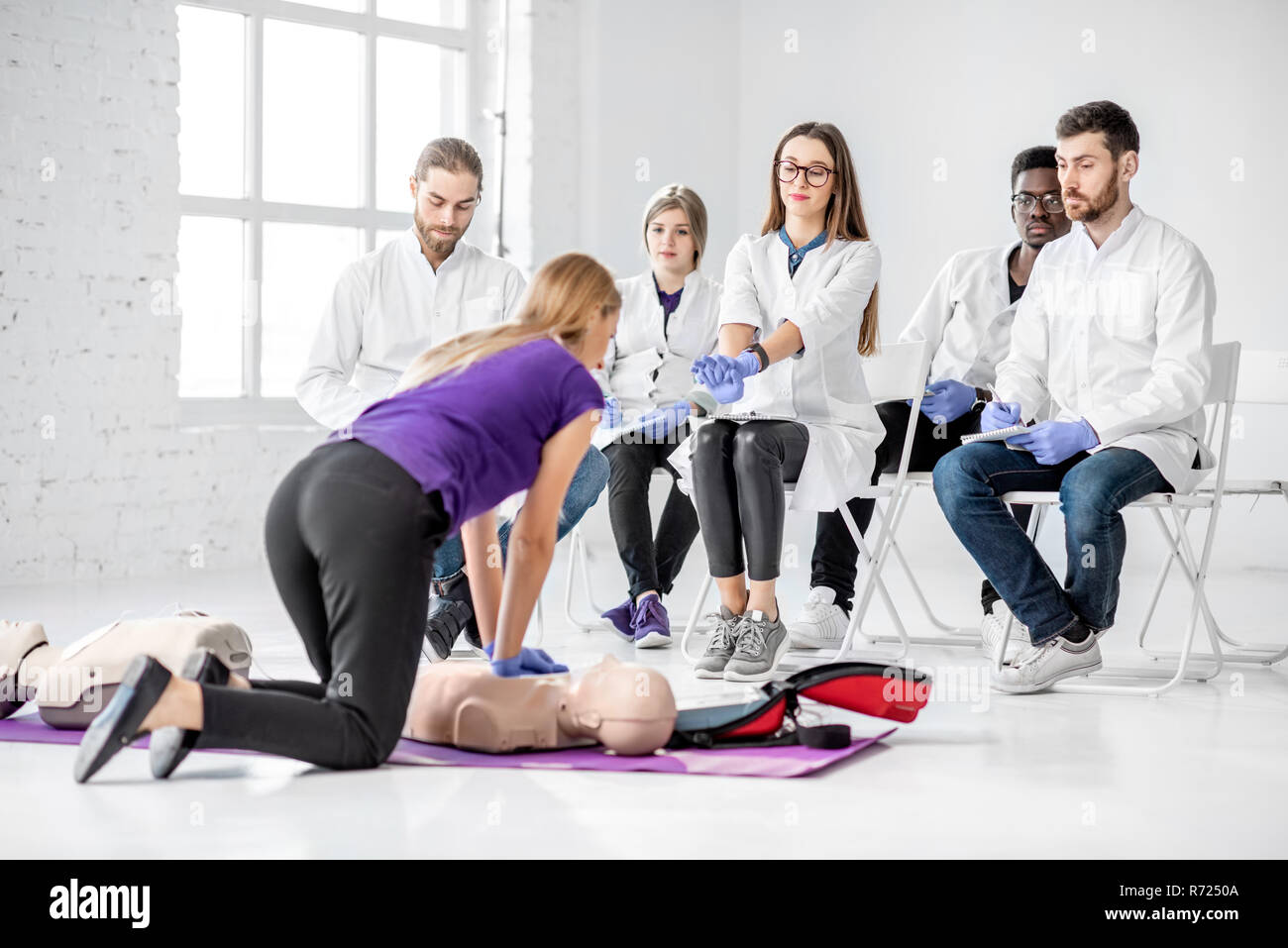 Group of medics sitting and listening to the instructor showing some ...