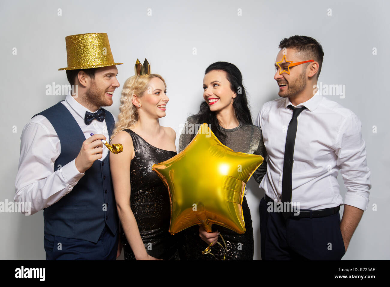 happy friends with golden party props posing Stock Photo - Alamy