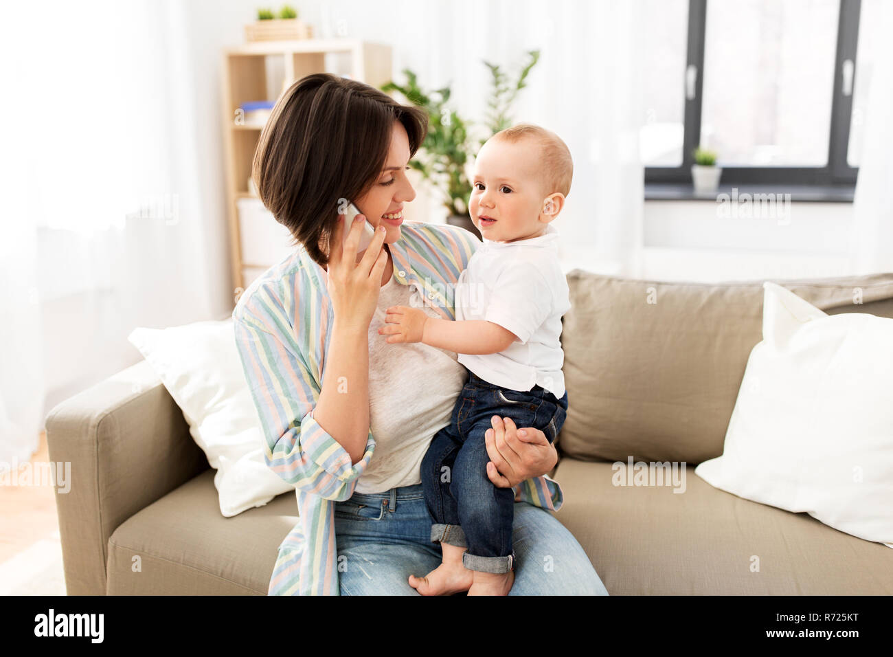 mother with baby son calling on smartphone Stock Photo - Alamy
