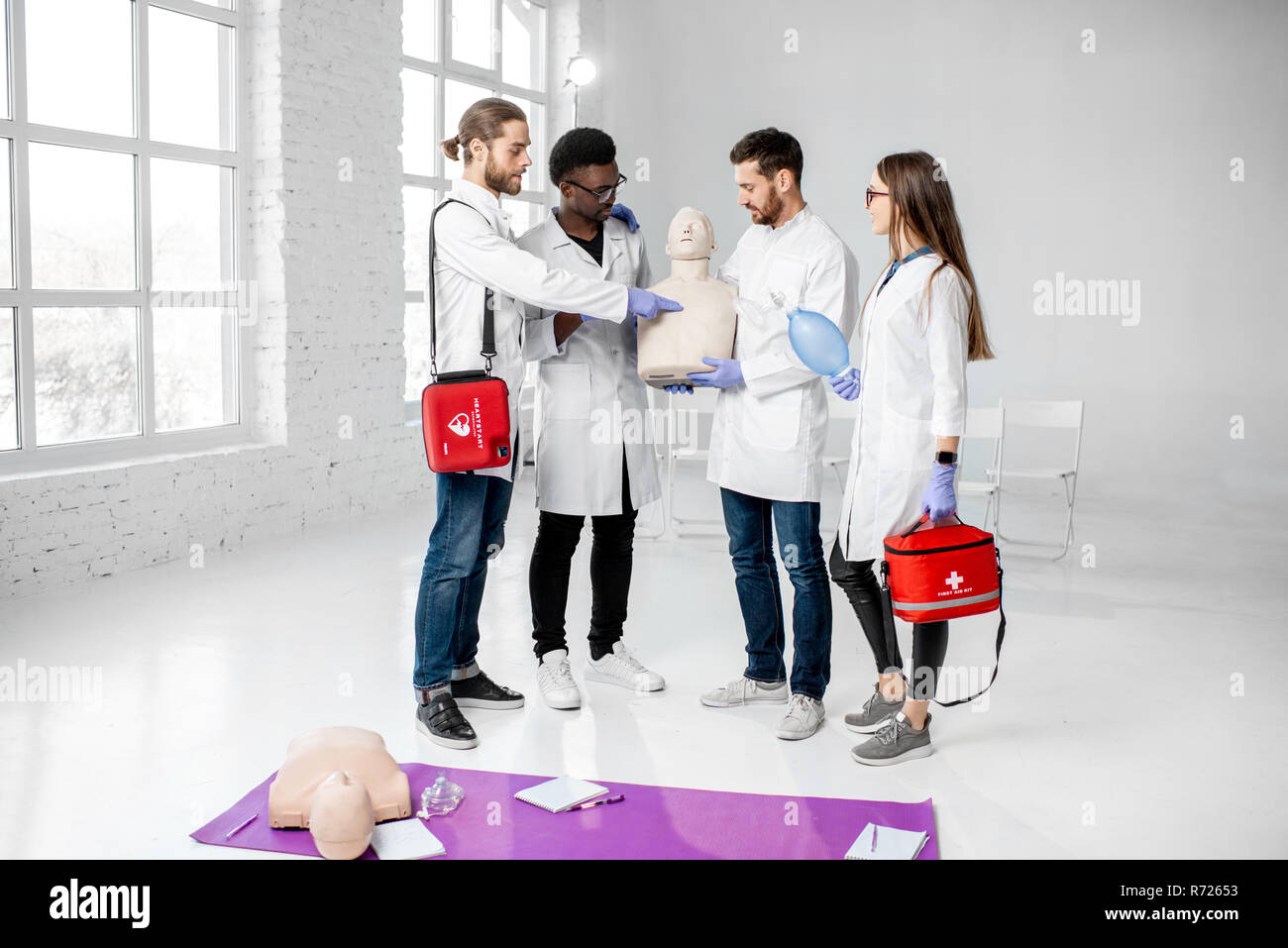 Portrait of a young team of medics in uniform standing together with ...