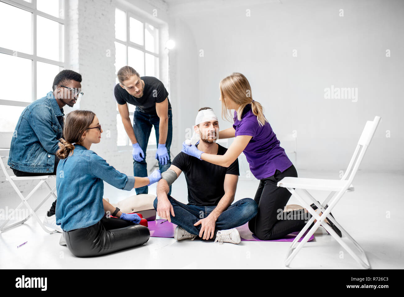Group of young people during the first aid training with instructor ...