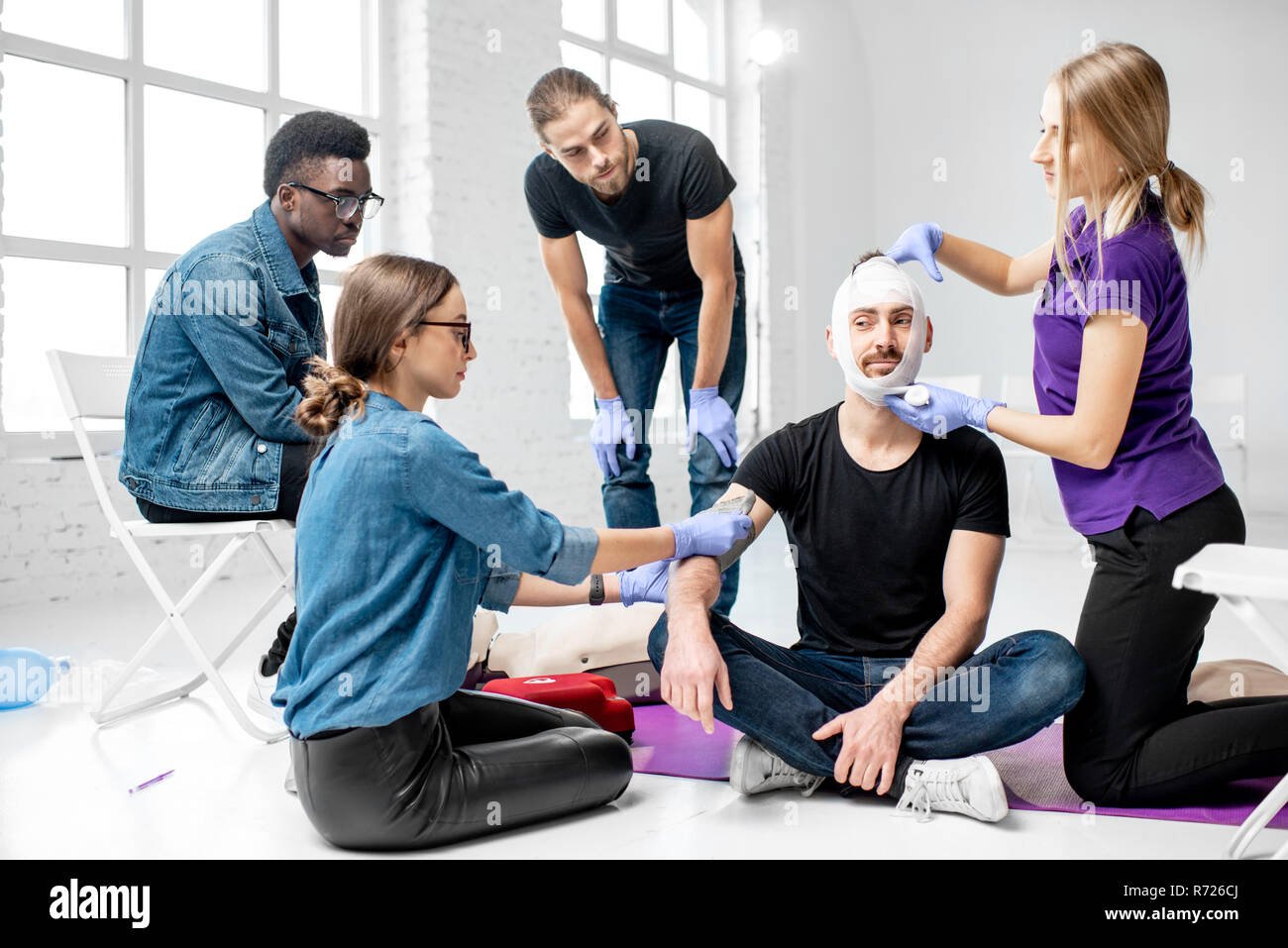 Group of young people during the first aid training with instructor ...