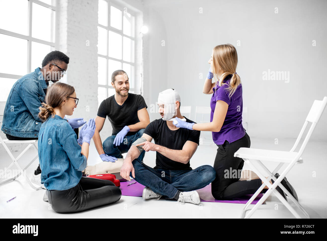 Group of young people during the first aid training with instructor ...