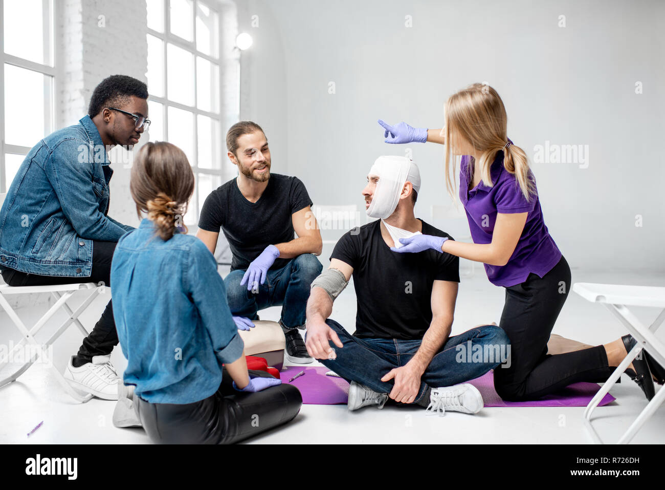 Group of young people during the first aid training with instructor ...