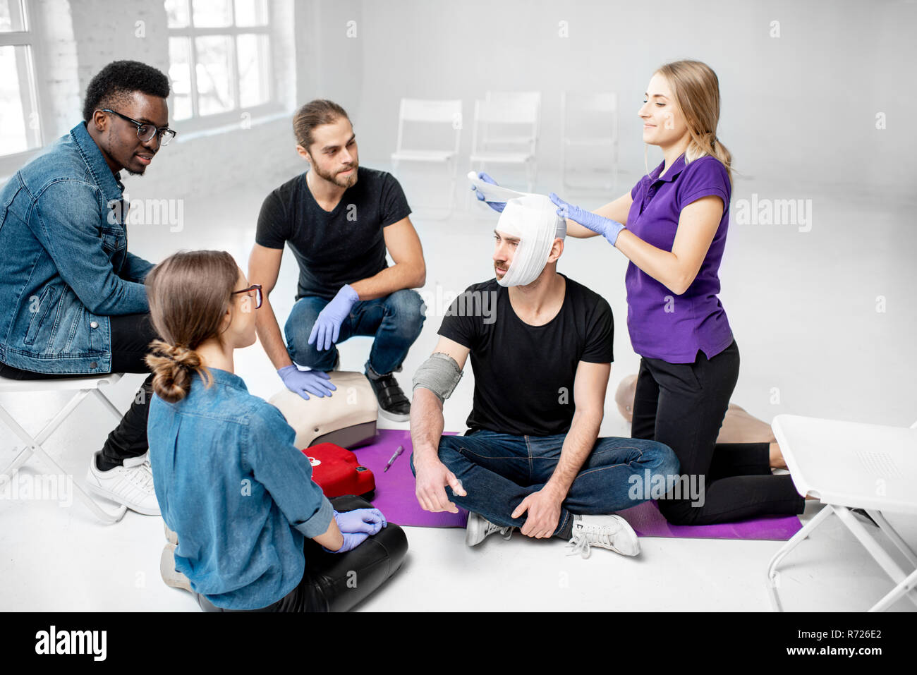 Group of young people during the first aid training with instructor ...