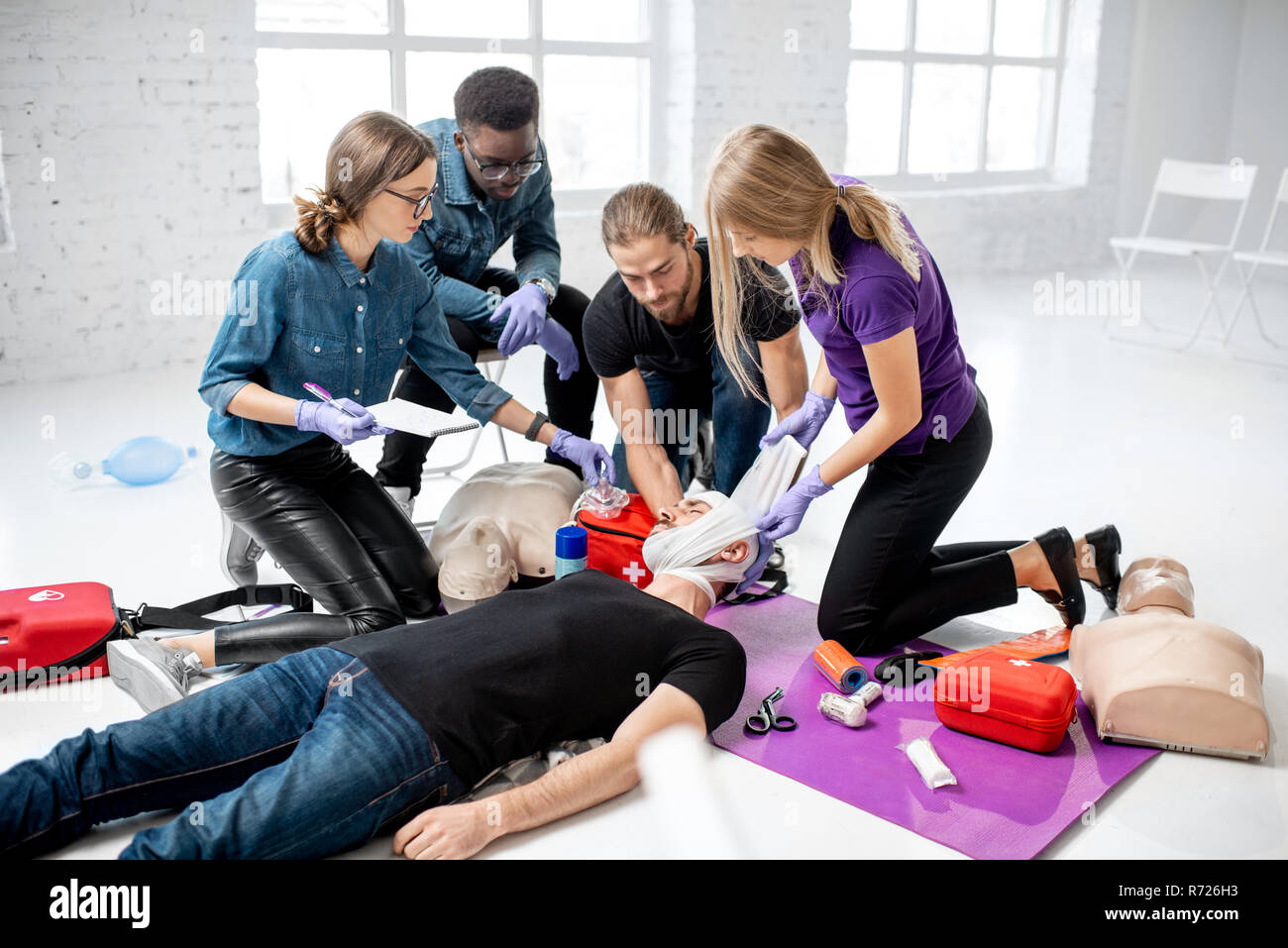 Group of young people during the first aid training with instructor ...