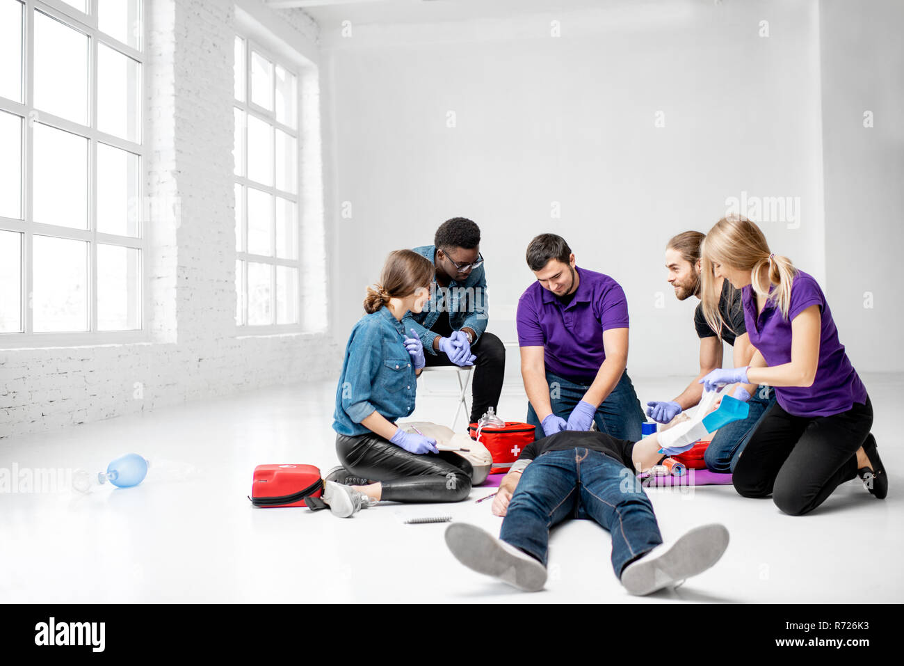 Group of young people during the first aid training with instructor ...