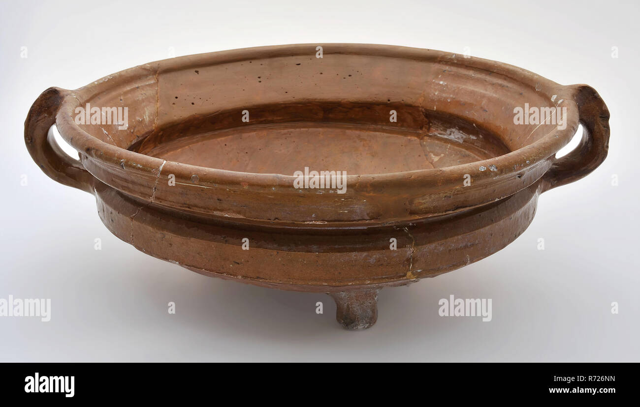 Pottery cooking pot with two standing pinched ears, on three legs, low ...