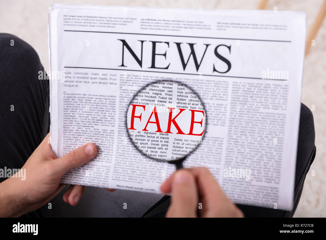 Man Examining Fake News On Newspaper Through Magnifying Glass Stock ...