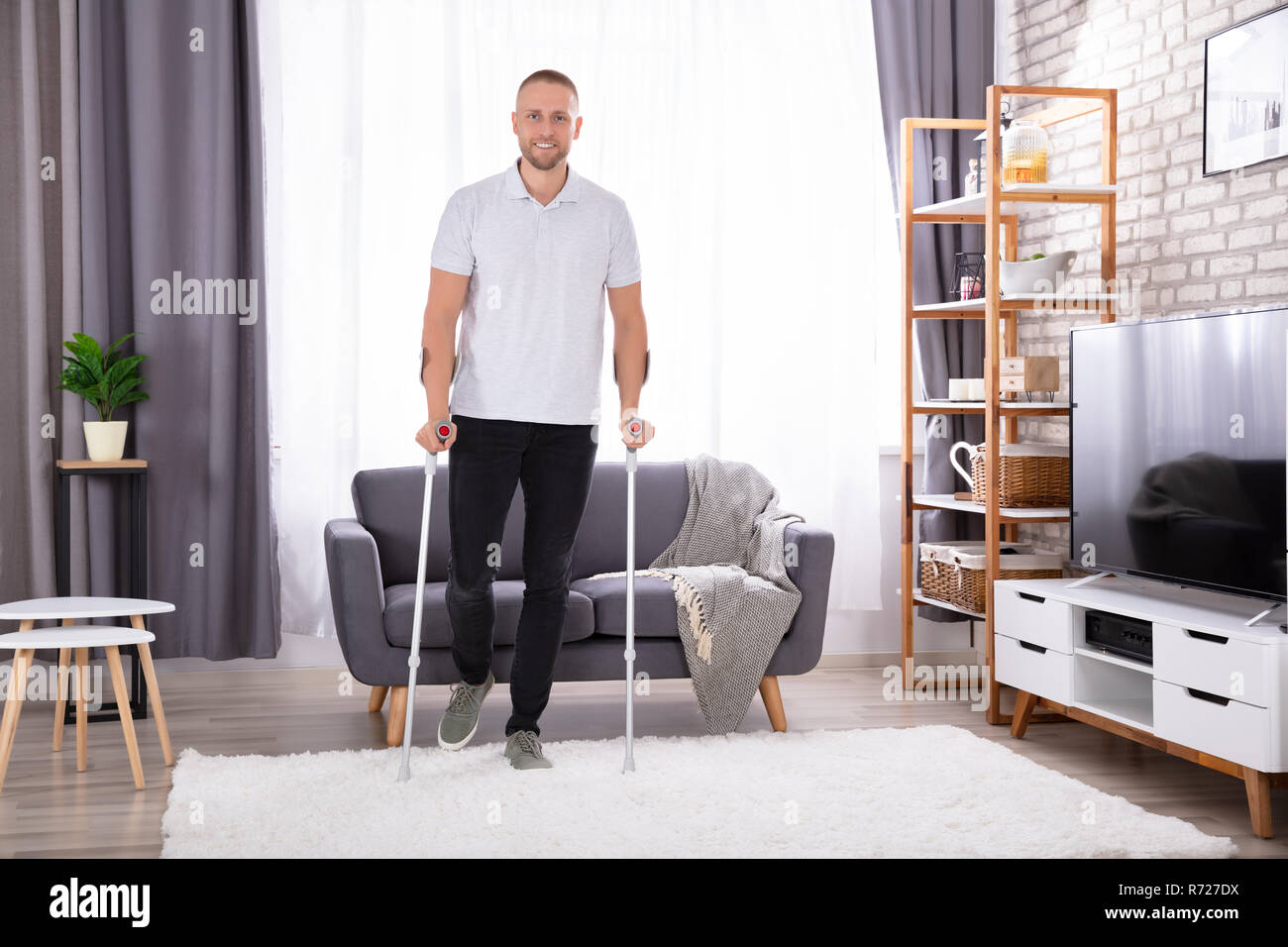 Patient walking on crutches hi-res stock photography and images - Alamy