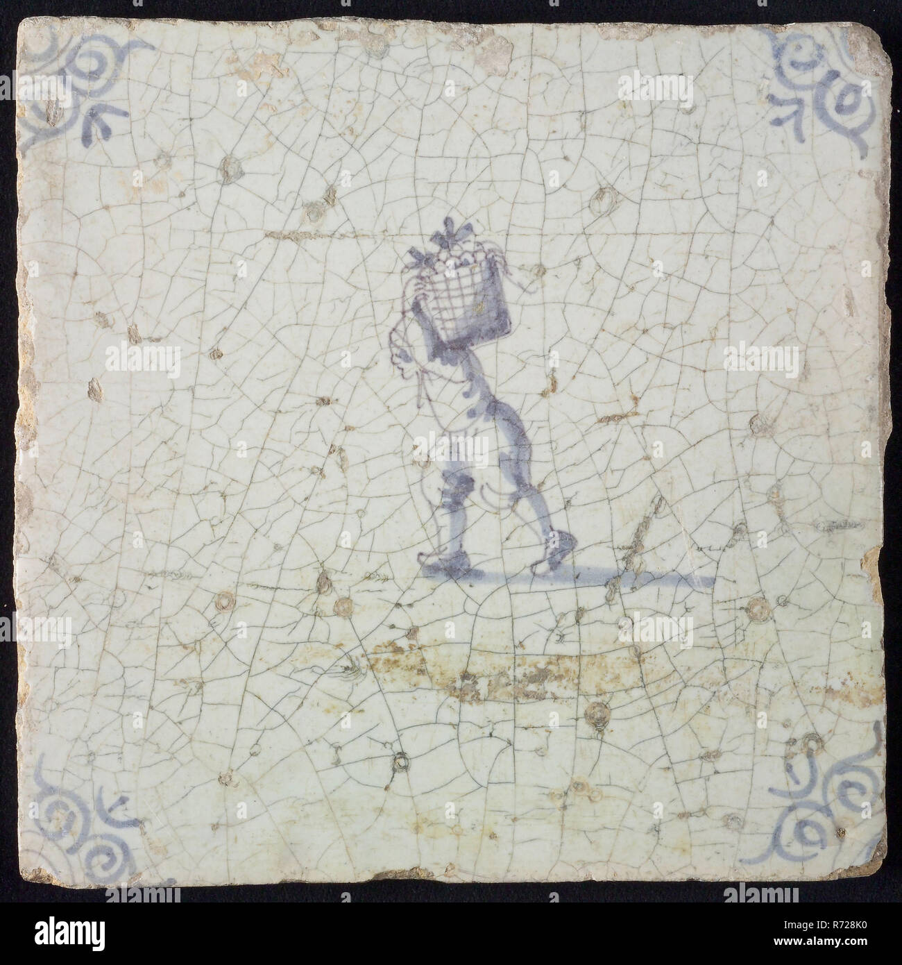 Occupation tile, blue with man crumbling with basket on the back ...