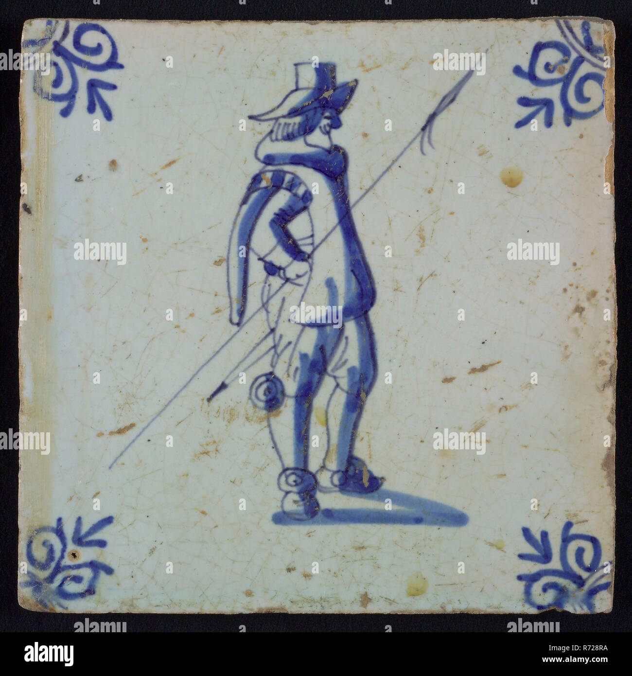 Occupation tile, blue with man with staff and horn In his hands, corner ...