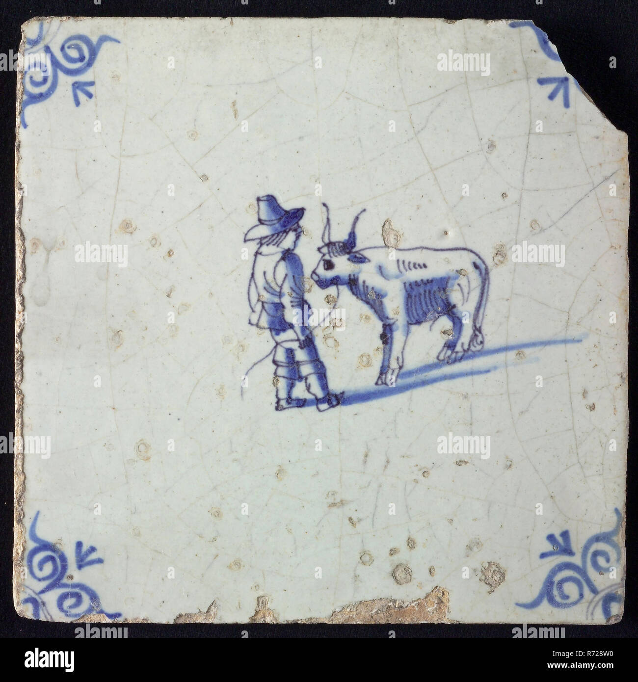 Figure tile, blue with farmer with cow, corner motif oxen head, wall ...
