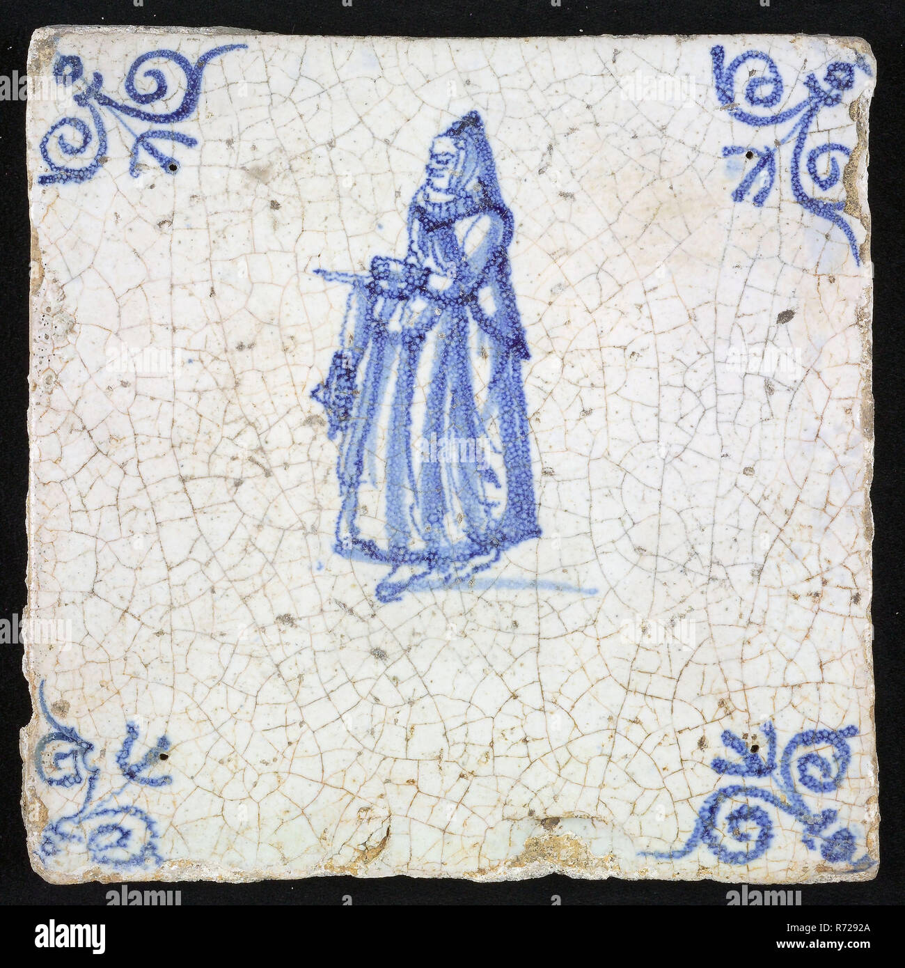 Figure tile, blue with lady with veil and millstone collar and has coil ...