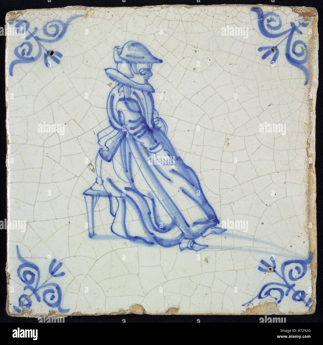 Figure tile, blue with lady sitting on stool, with hat, wide collar and ...