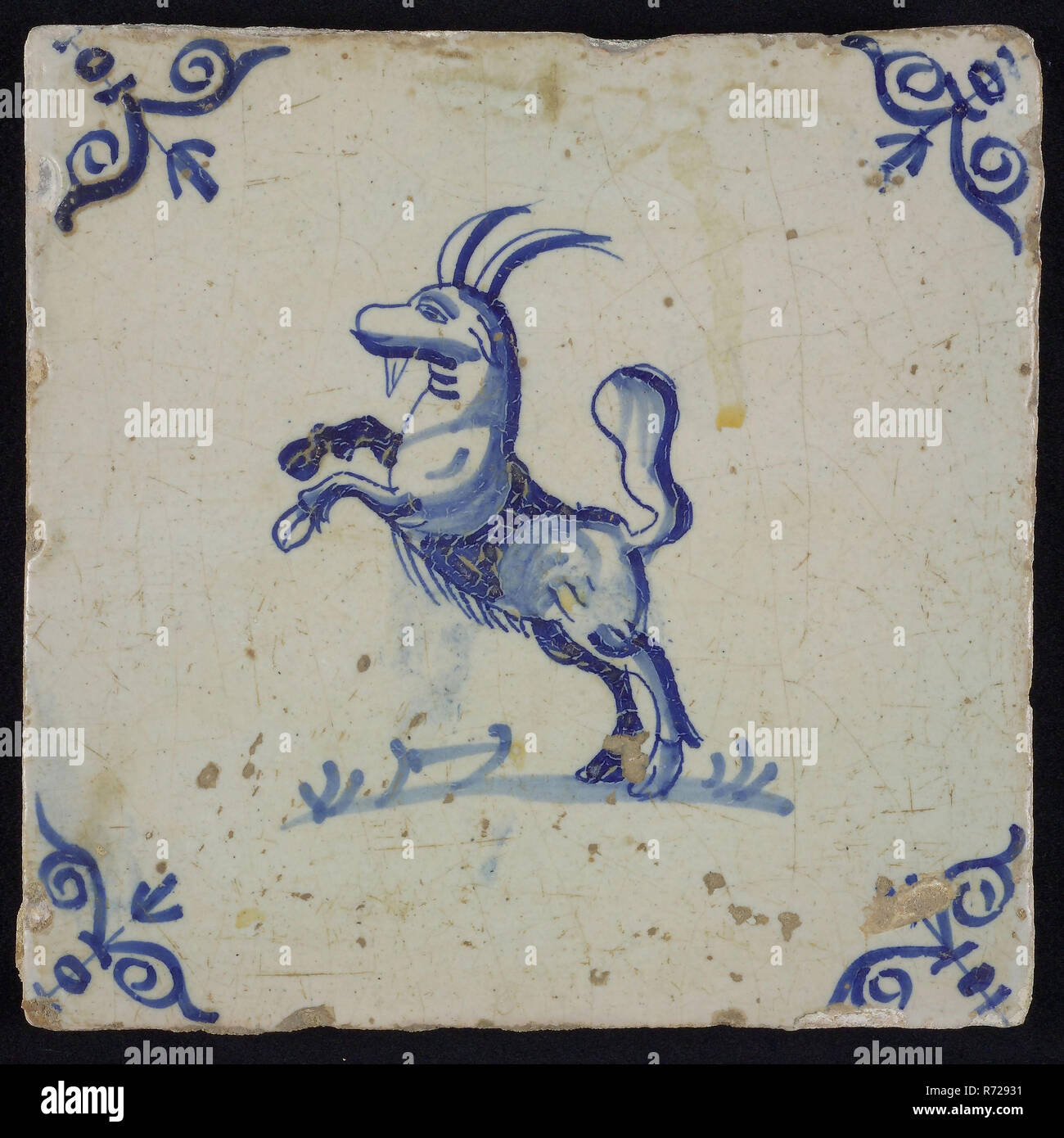 Animal tile, jumping goat to the left on piece of ground, in blue on ...