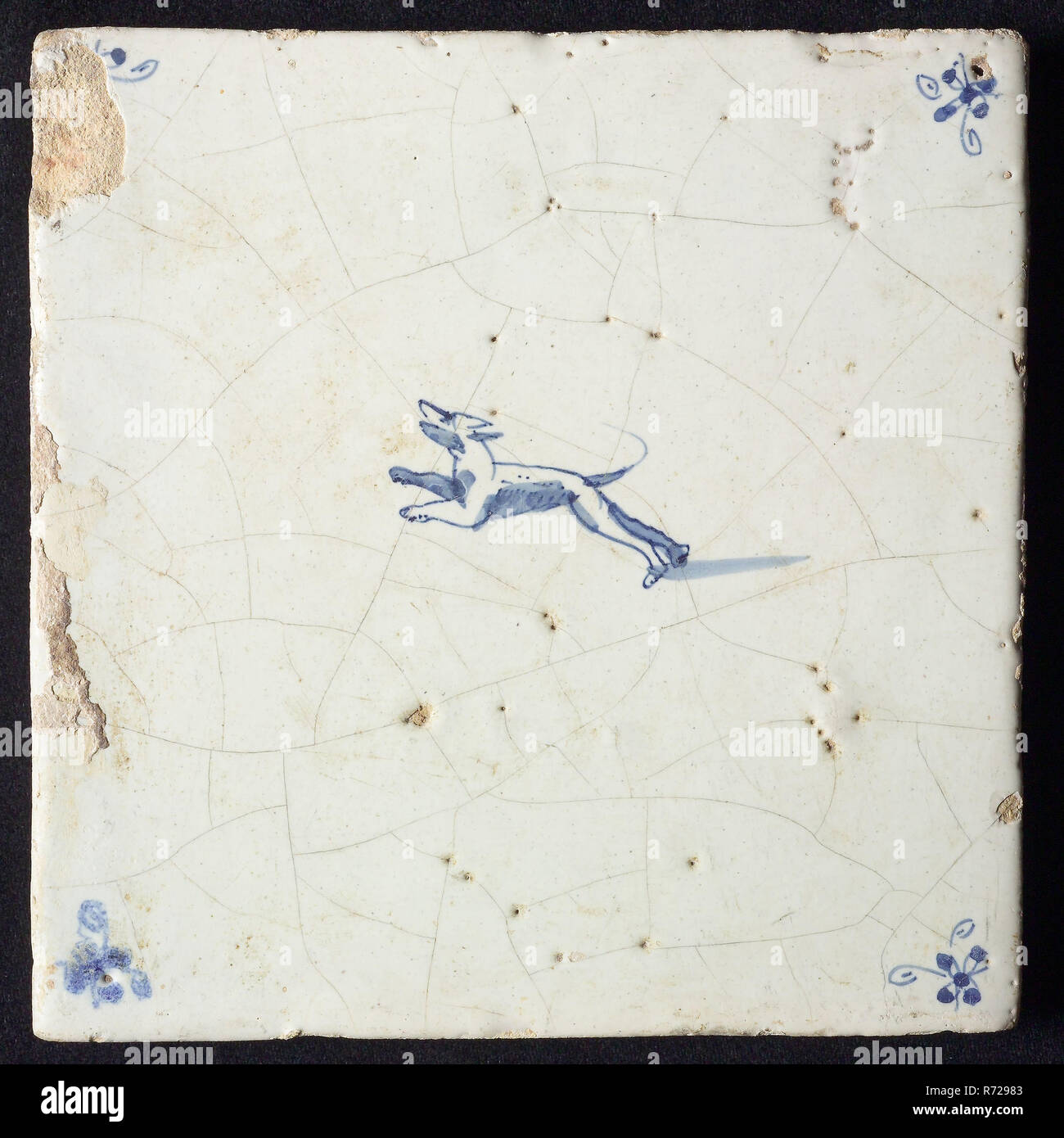 Animal tile, jumping dog to the left, in blue on white, corner motif ...