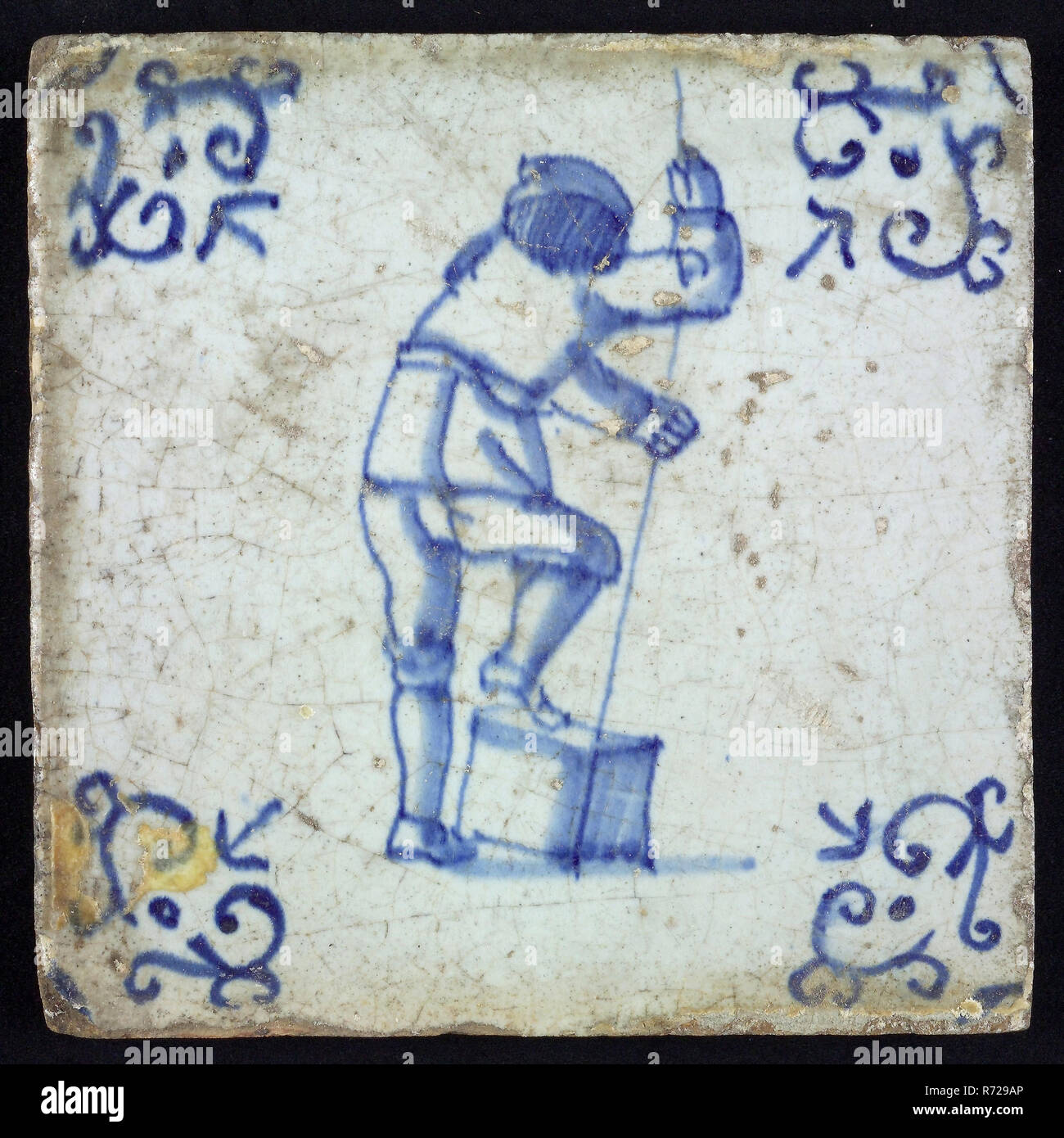 Figure tile, blue with man standing with one leg on chest with rope or ...