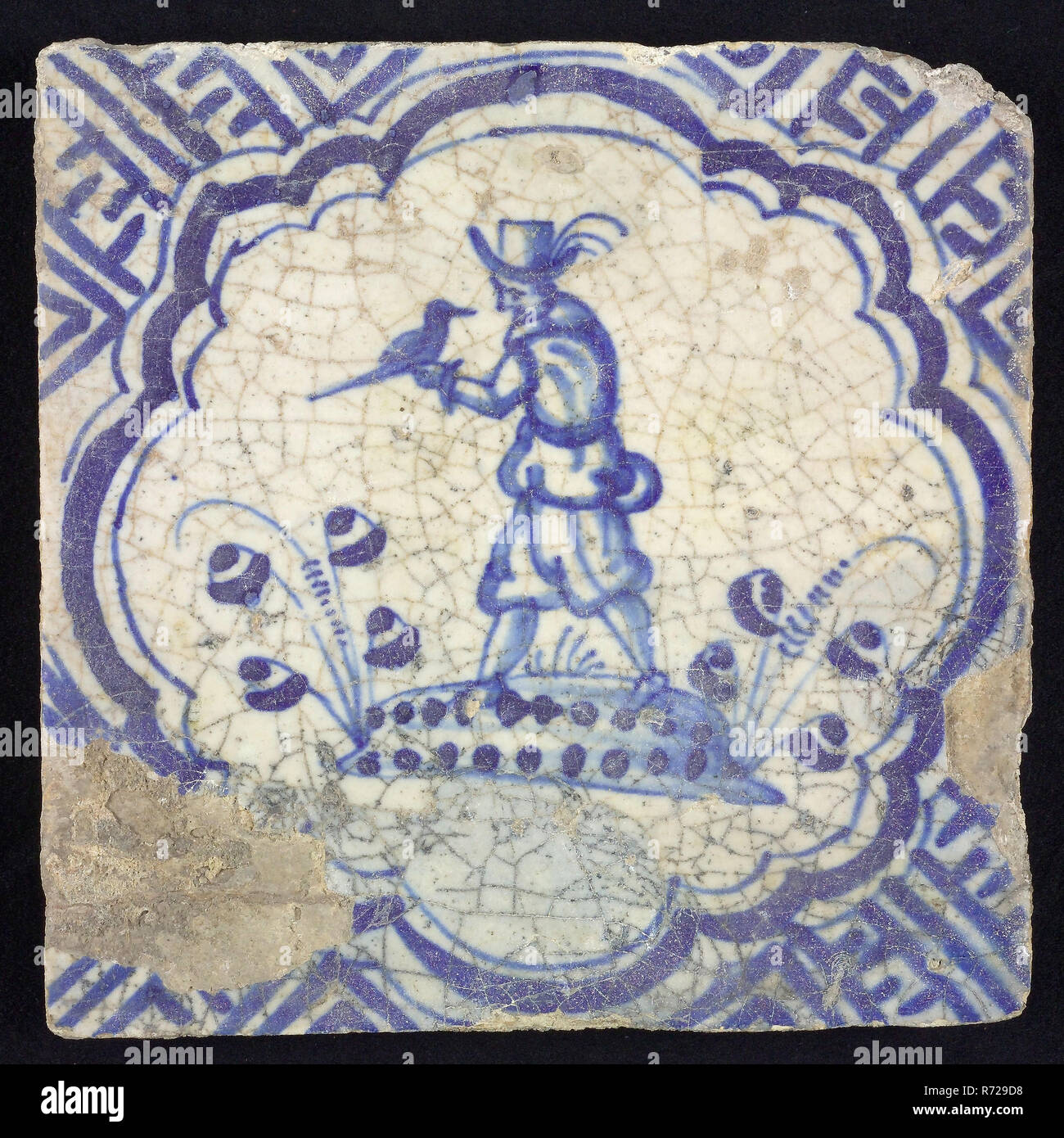 Figure tile, blue with falconer with falcon on the left hand, on ground ...