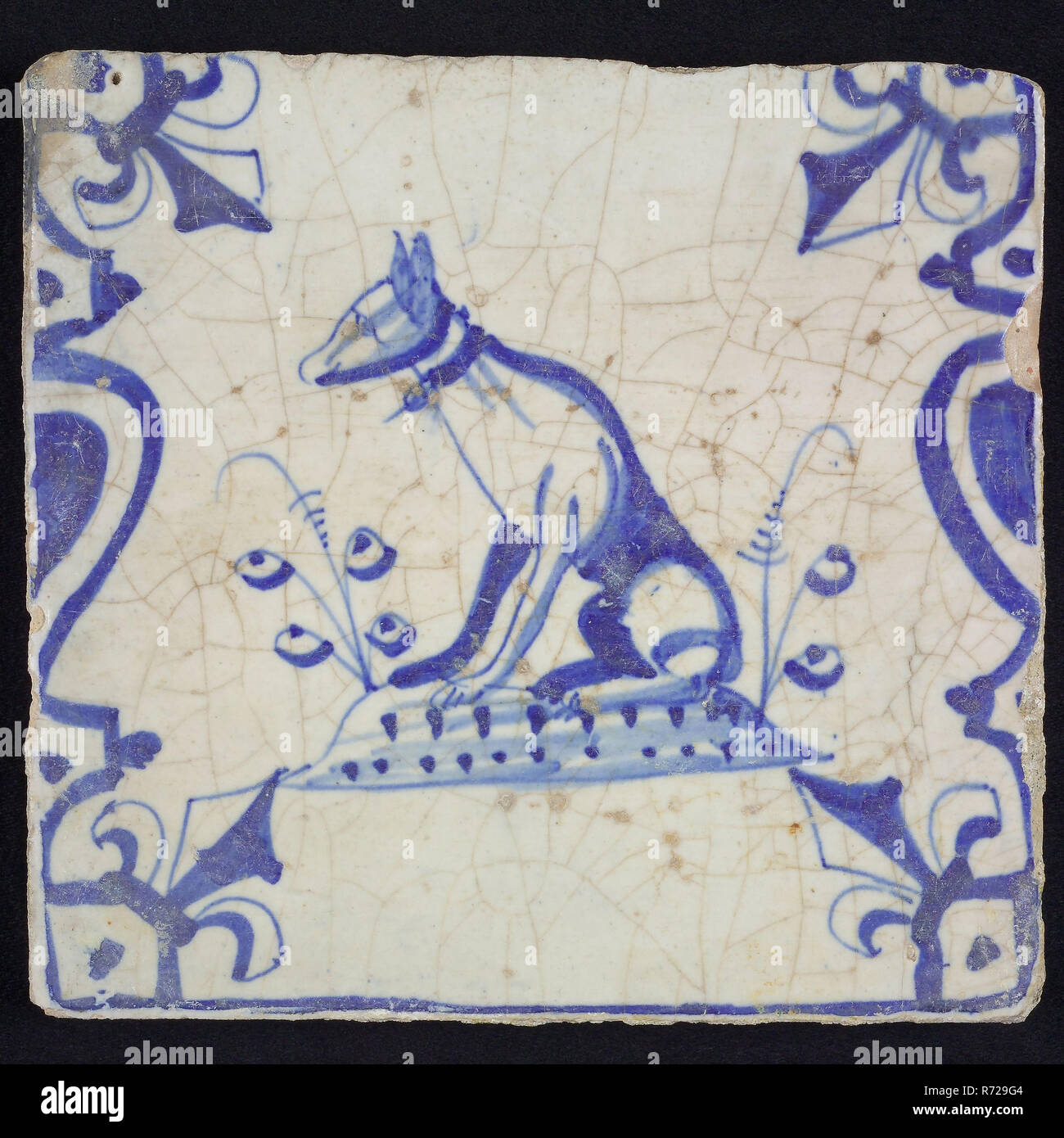 Animal tile, sitting dog to the left on plot between balusters, in blue ...