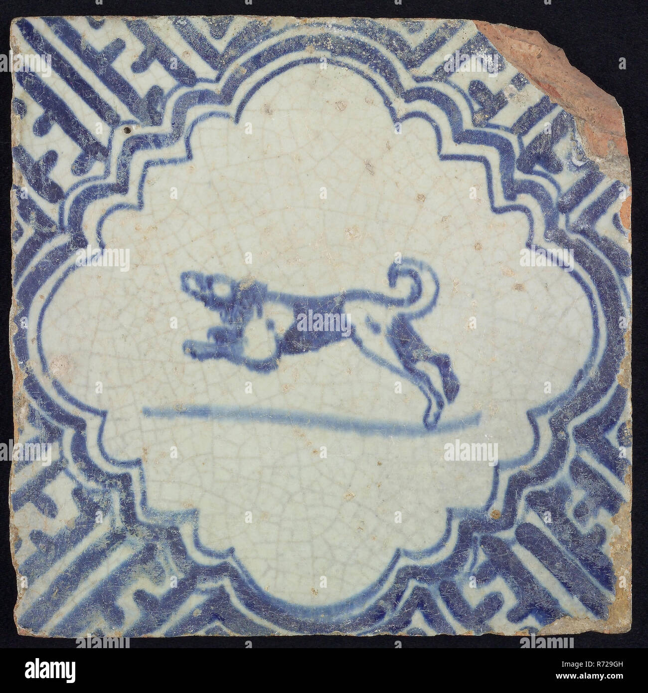 Animal tile, running dog to the left within scalloped frame with braces ...