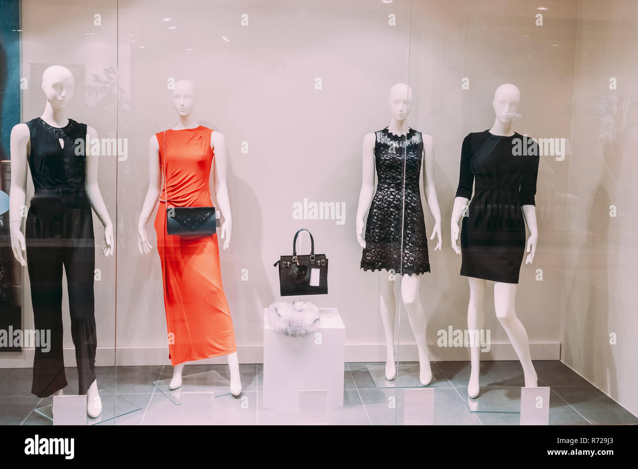 Four Mannequins Standing In Store Window Display Of Women's Casual ...