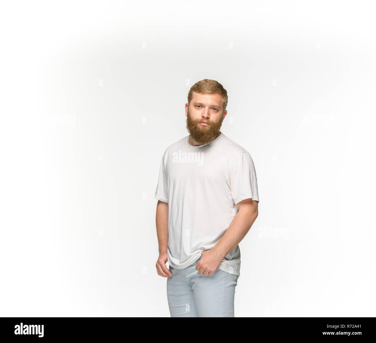 Closeup of young man's body in empty white t-shirt isolated on white ...