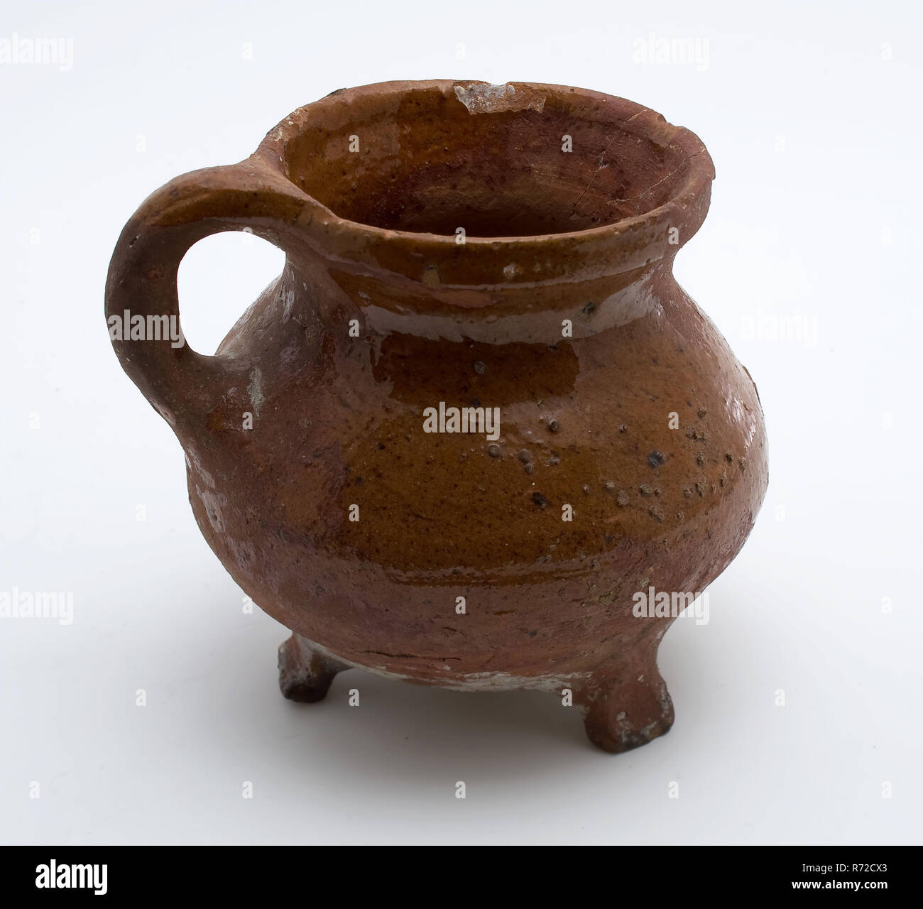 Pottery cooking jug, red shard, glazed, vertical sausage ear, on three ...