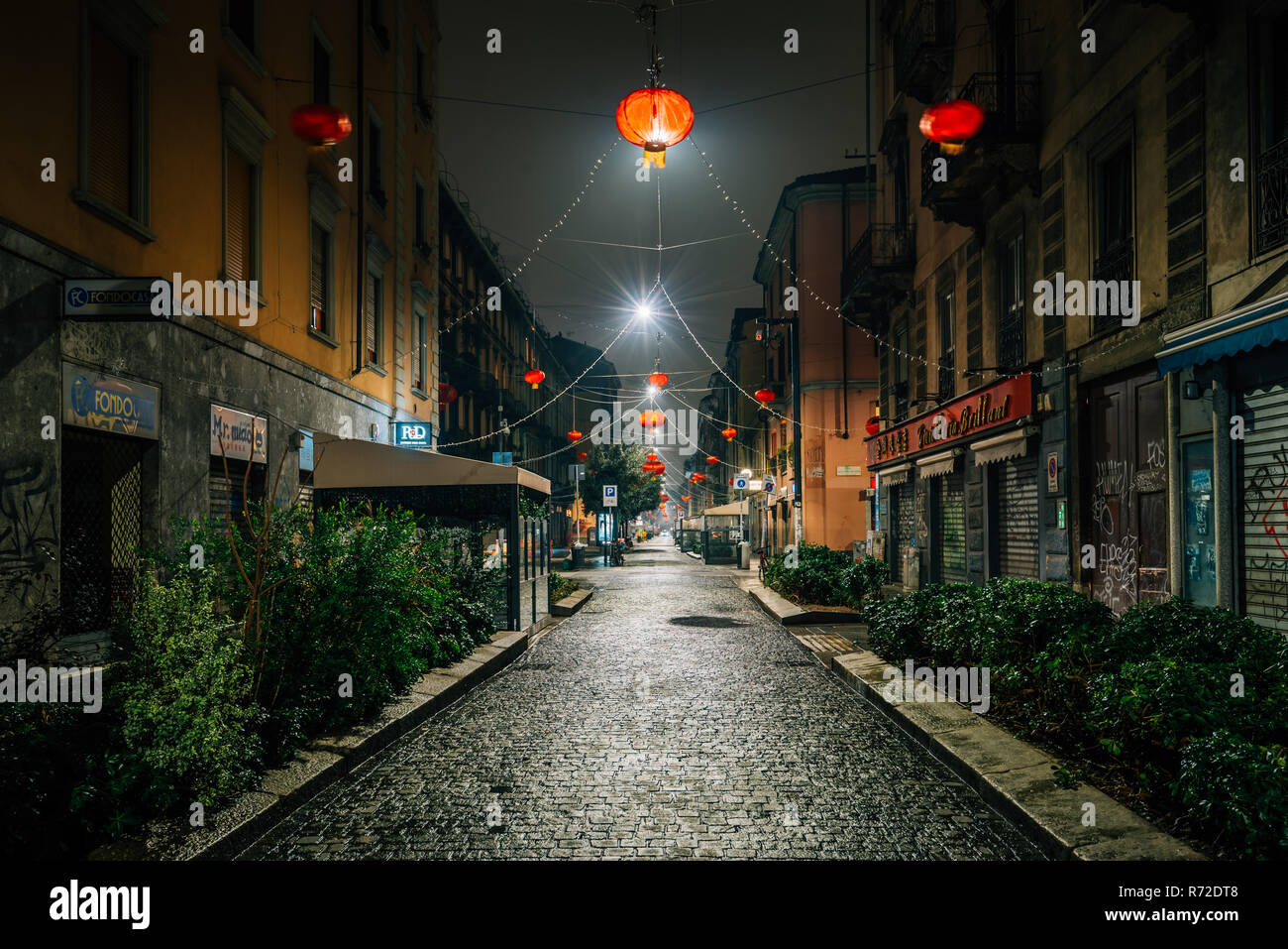 A cobblestone street and Chinese lanterns in Chinatown, Milan, Italy ...