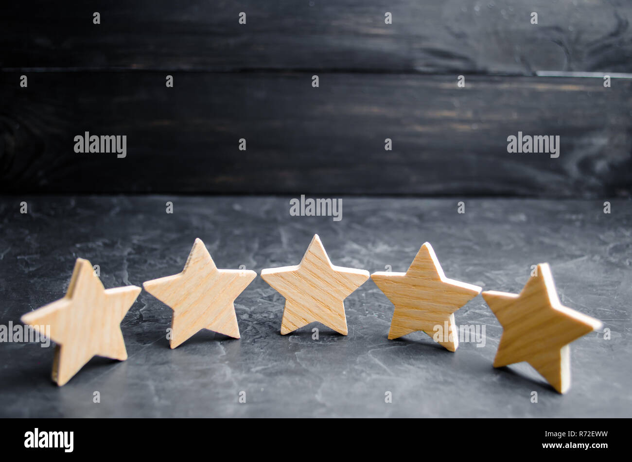 Five wooden stars. Get the fifth star. The concept of the rating of ...