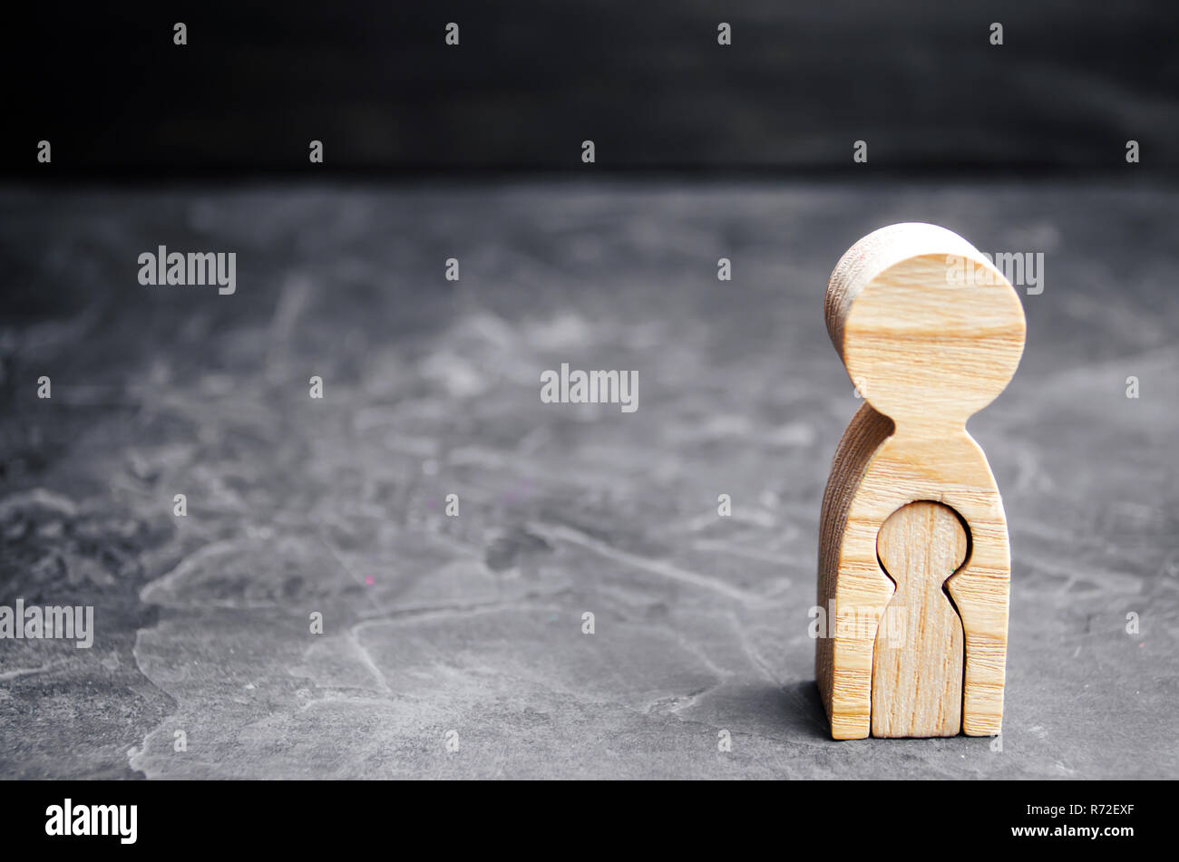 The wooden figure of a woman with a child inside. The concept of ...