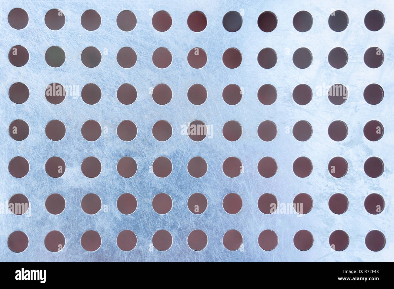 Steel patterned background with holes Stock Photo - Alamy
