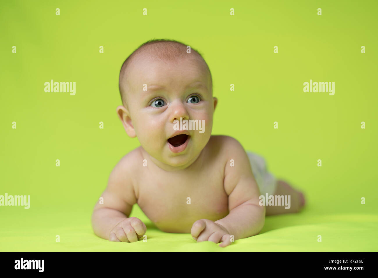 Cute happy baby girl crawling Stock Photo - Alamy