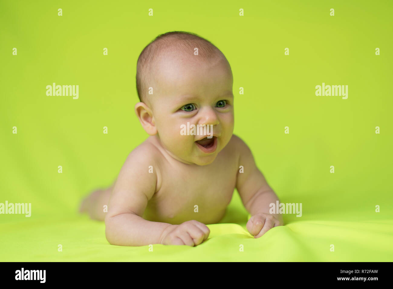 Cute happy baby girl crawling Stock Photo - Alamy