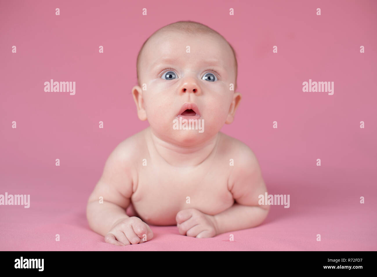 Cute happy baby girl crawling Stock Photo - Alamy