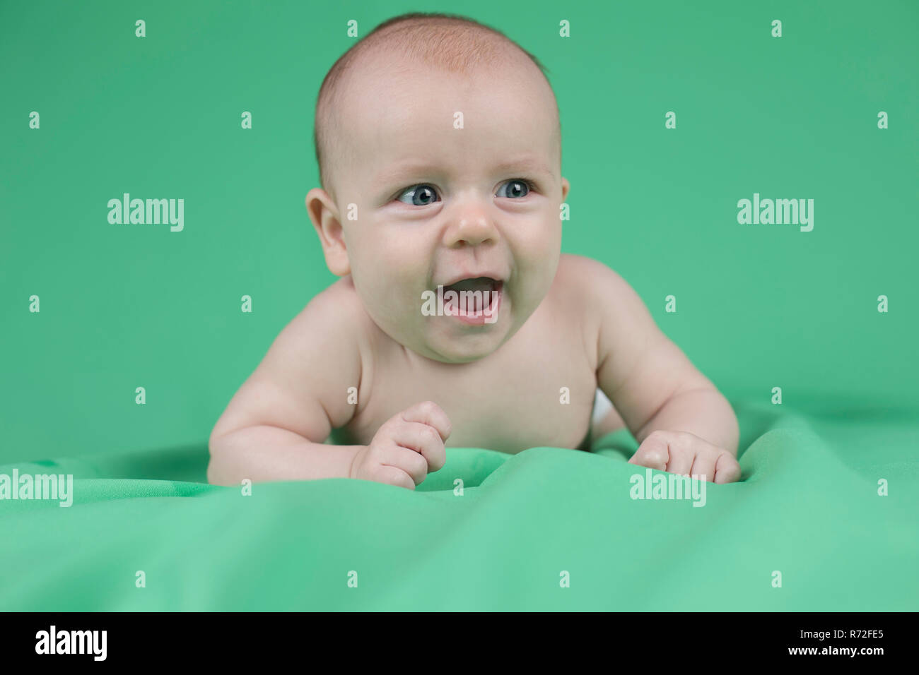 Cute happy baby girl crawling Stock Photo - Alamy