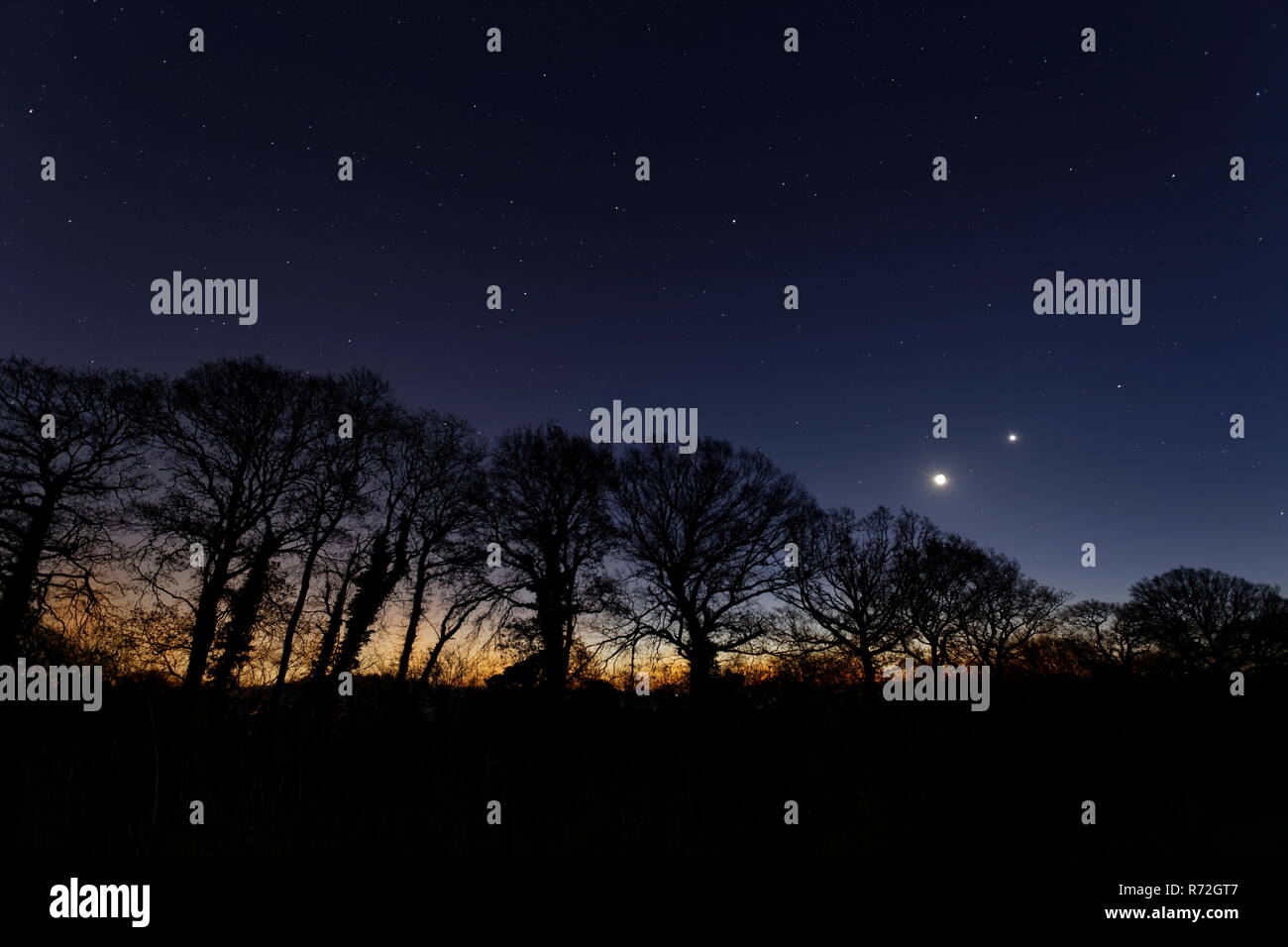 The moon and venus shine bright in the early morning dawn just above ...