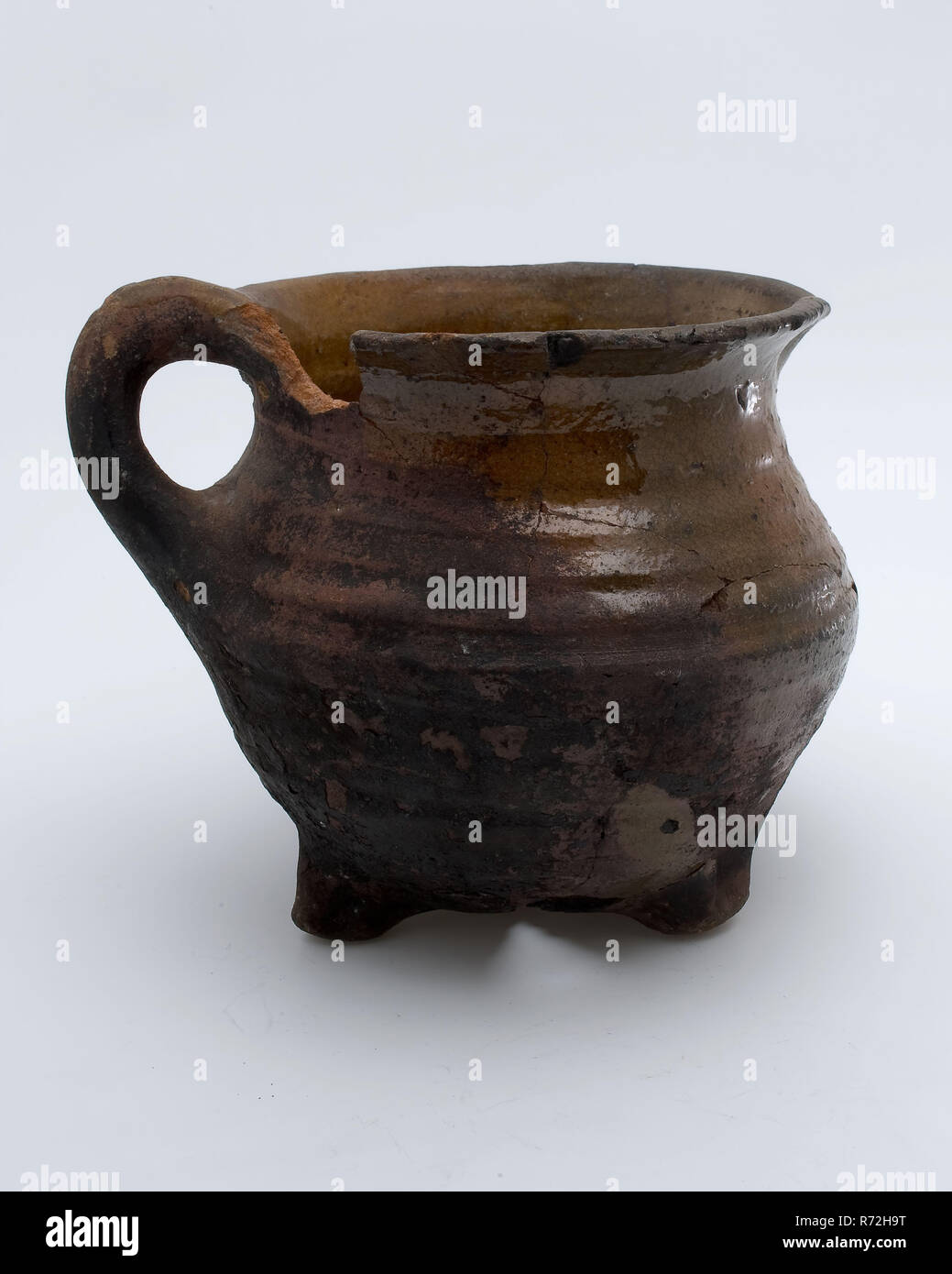 Pottery cooking jug, grape model, vertical sausage ear, on three legs ...